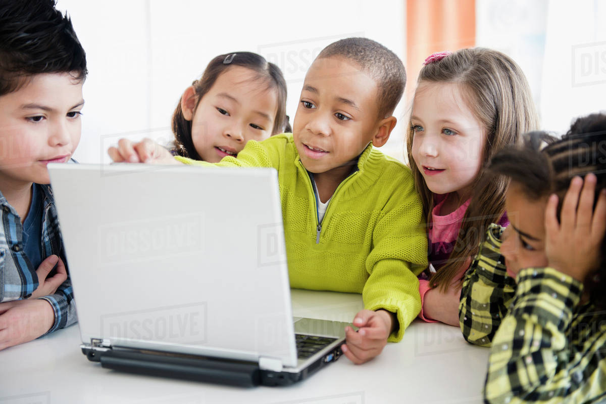 Children using laptop together - Royalty-free Stock Photo | Dissolve
