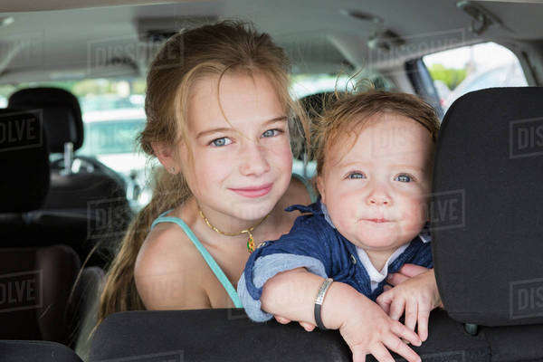 Caucasian children sitting in backseat of car - Royalty-free Stock ...