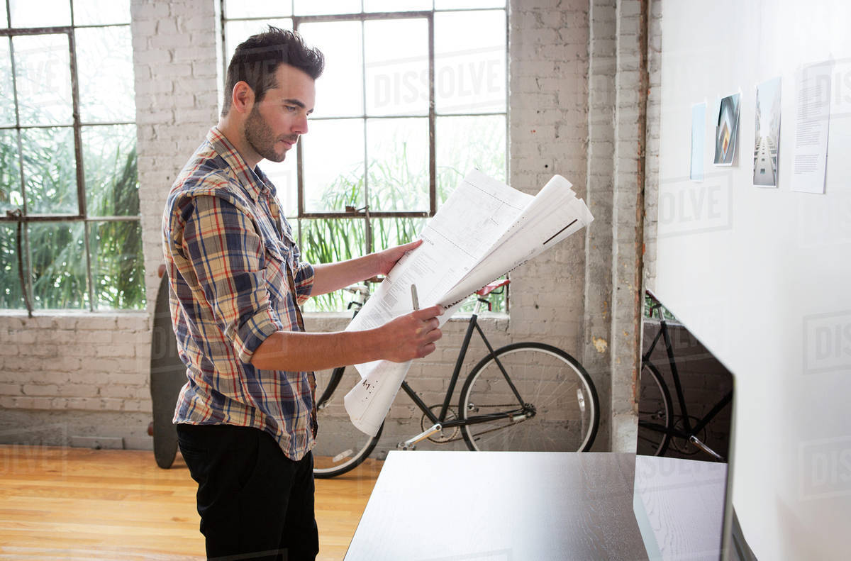 Caucasian architect reading blueprints in office - Royalty-free Stock ...