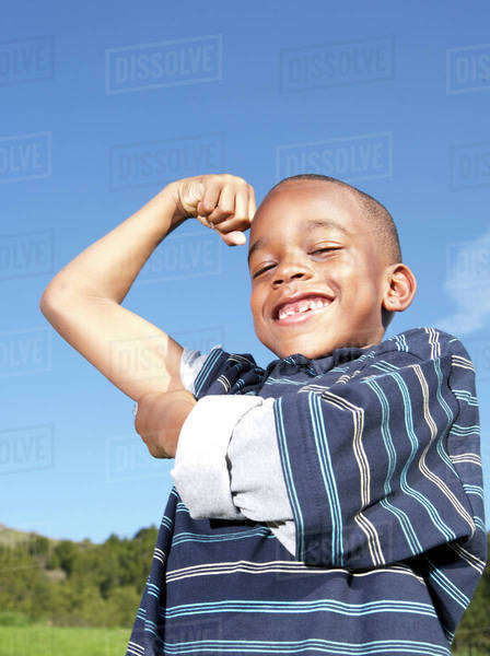 African American boy flexing his muscles - Royalty-free Stock Photo ...