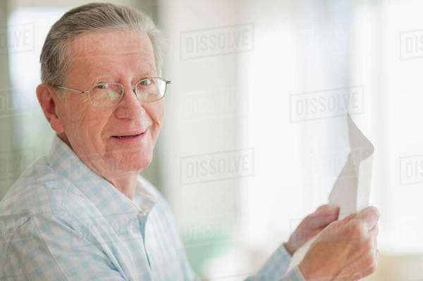Senior Caucasian man reading letter - Royalty-free Stock Photo | Dissolve