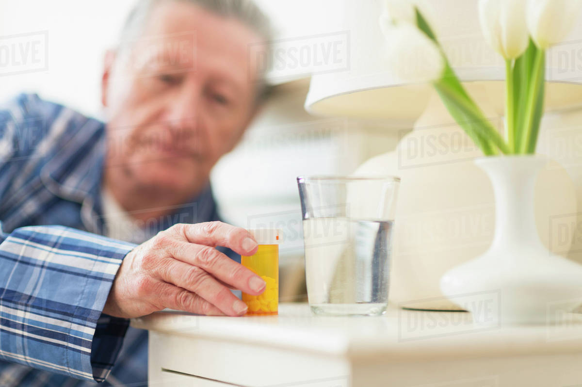 Senior Caucasian man taking medication - Royalty-free Stock Photo ...