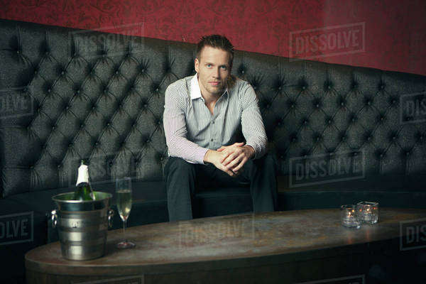 Caucasian man sitting in nightclub - Royalty-free Stock Photo | Dissolve