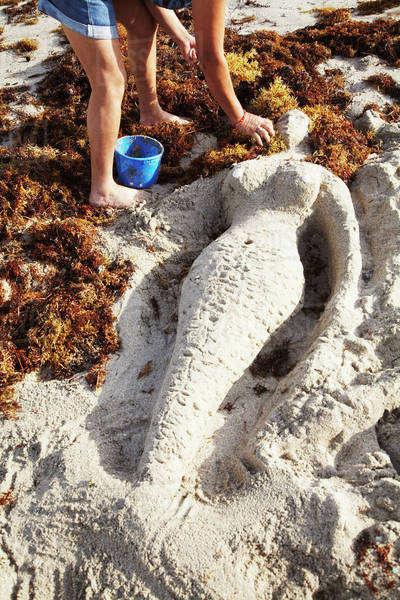 Mermaid sculpture in sand on beach - Stock Photo - Dissolve