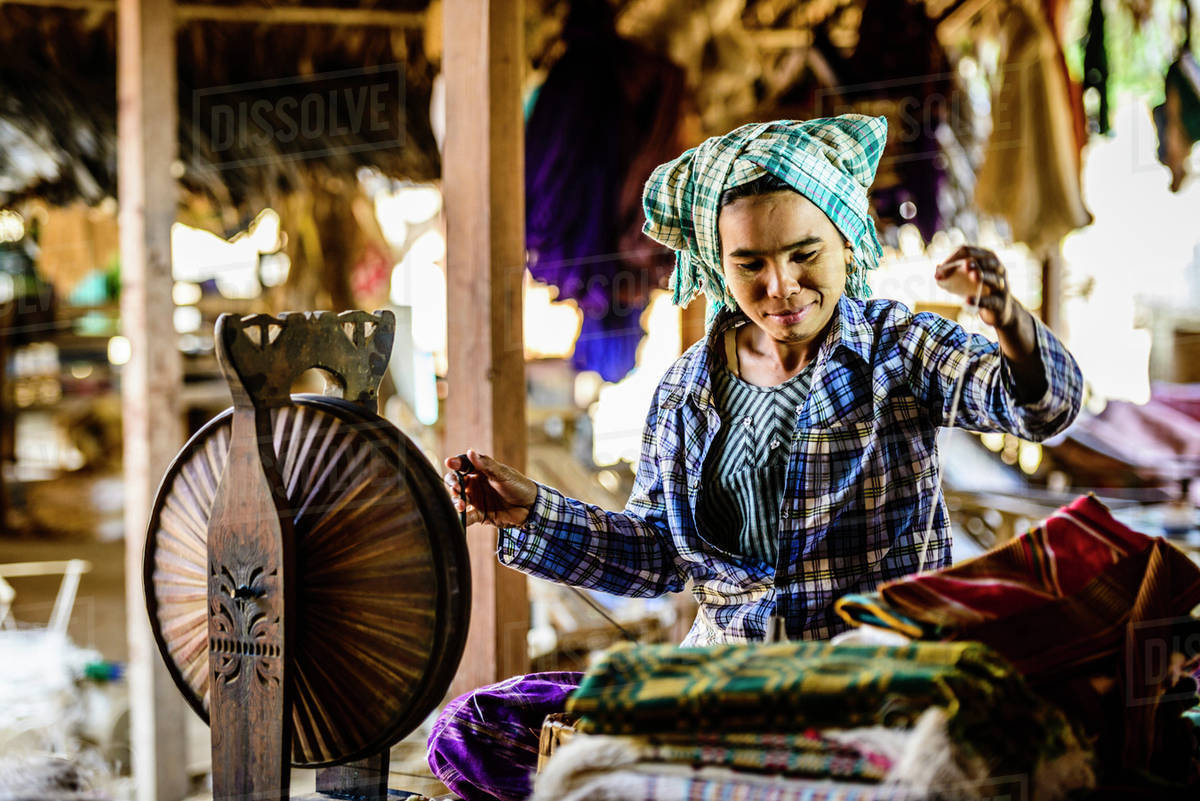 Asian woman spinning thread - Royalty-free Stock Photo | Dissolve