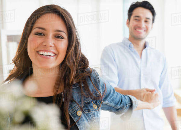 Woman pulling hand of boyfriend - Royalty-free Stock Photo | Dissolve
