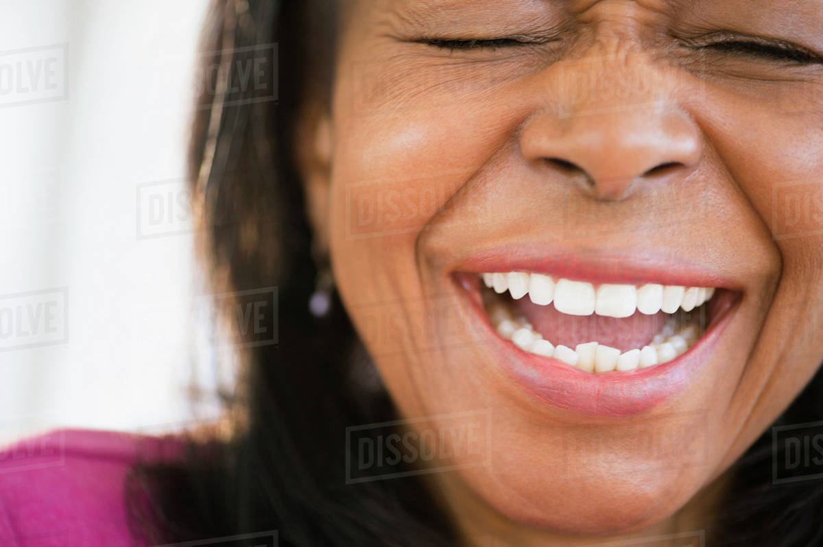 Close up of mixed race woman laughing - Royalty-free Stock Photo | Dissolve