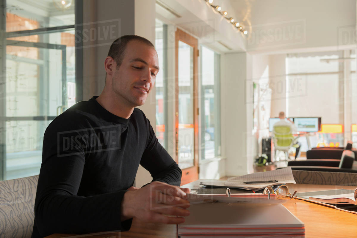 Caucasian businessman reading at desk - Royalty-free Stock Photo | Dissolve