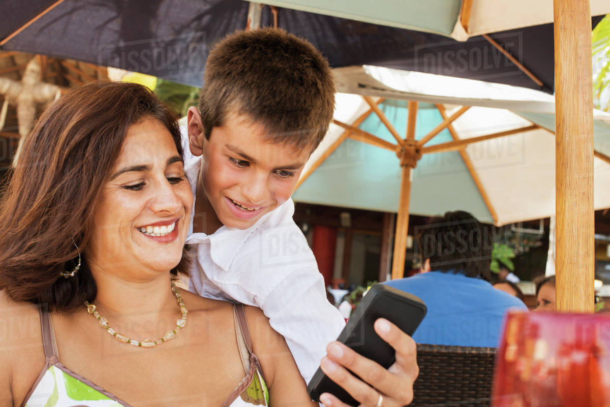 Mother and son using cell phone - Royalty-free Stock Photo | Dissolve