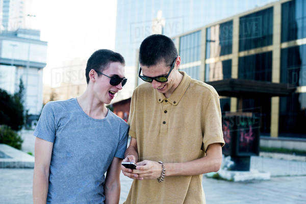 Caucasian men using cell phone in city - Royalty-free Stock Photo ...