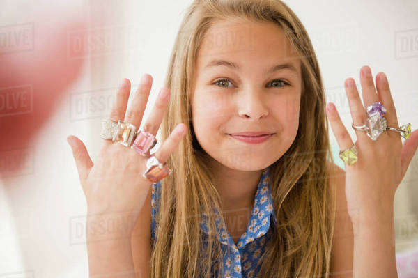 Caucasian girl wearing costume rings - Stock Photo - Dissolve