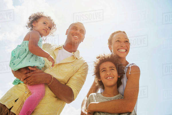 Low angle view of family smiling together outdoors - Royalty-free Stock ...