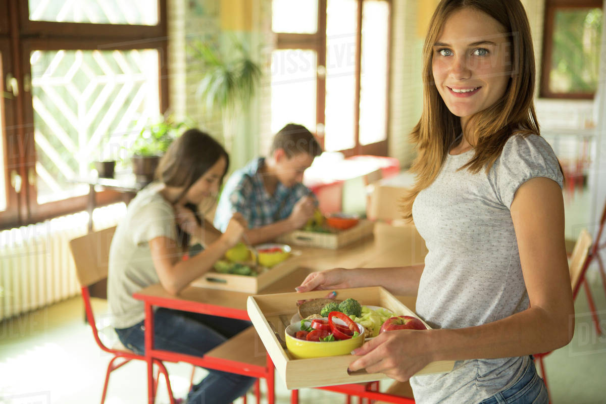 Student carrying lunch tray in school cafeteria - Royalty-free Stock ...