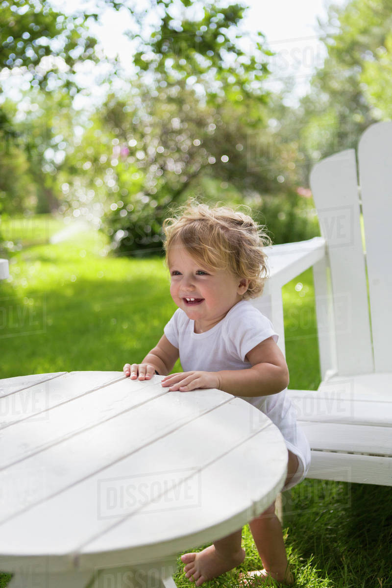 Caucasian baby boy standing at table in backyard - Royalty-free Stock ...