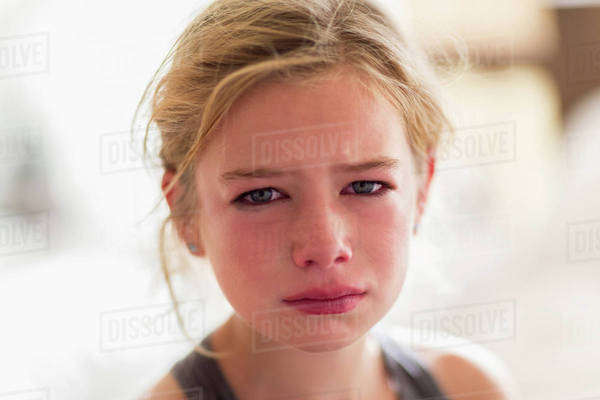 Close up of red face of crying Caucasian girl - Stock Photo - Dissolve