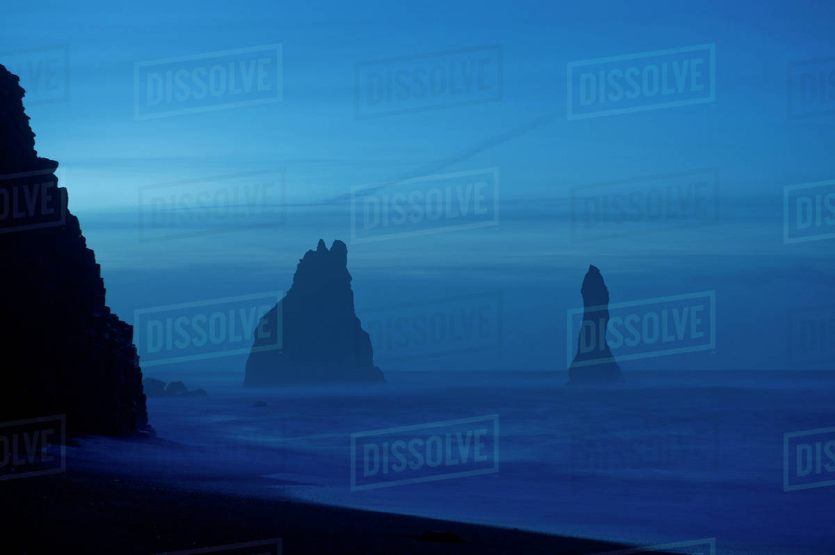 Rock formations in ocean at misty beach - Royalty-free Stock Photo ...