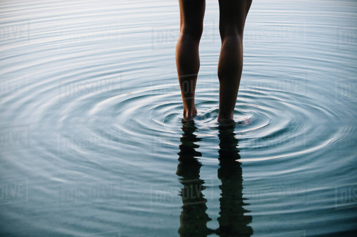 Reflection of legs of Korean woman with ripples in water - Royalty-free ...
