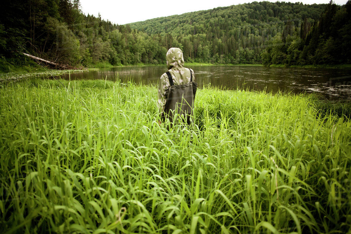 Mari man in wading boots standing in tall marsh grass - Royalty-free ...