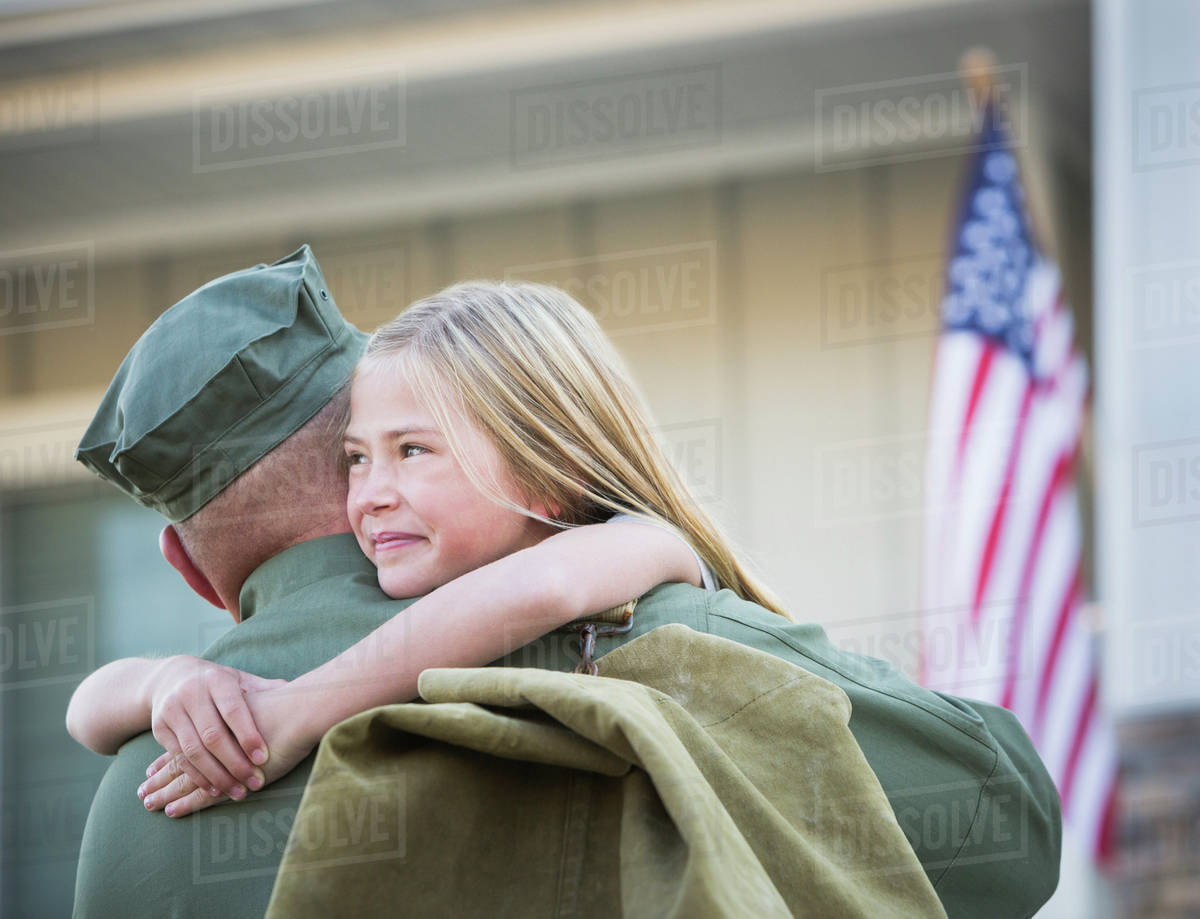 Returning Caucasian soldier hugging daughter - Royalty-free Stock Photo ...
