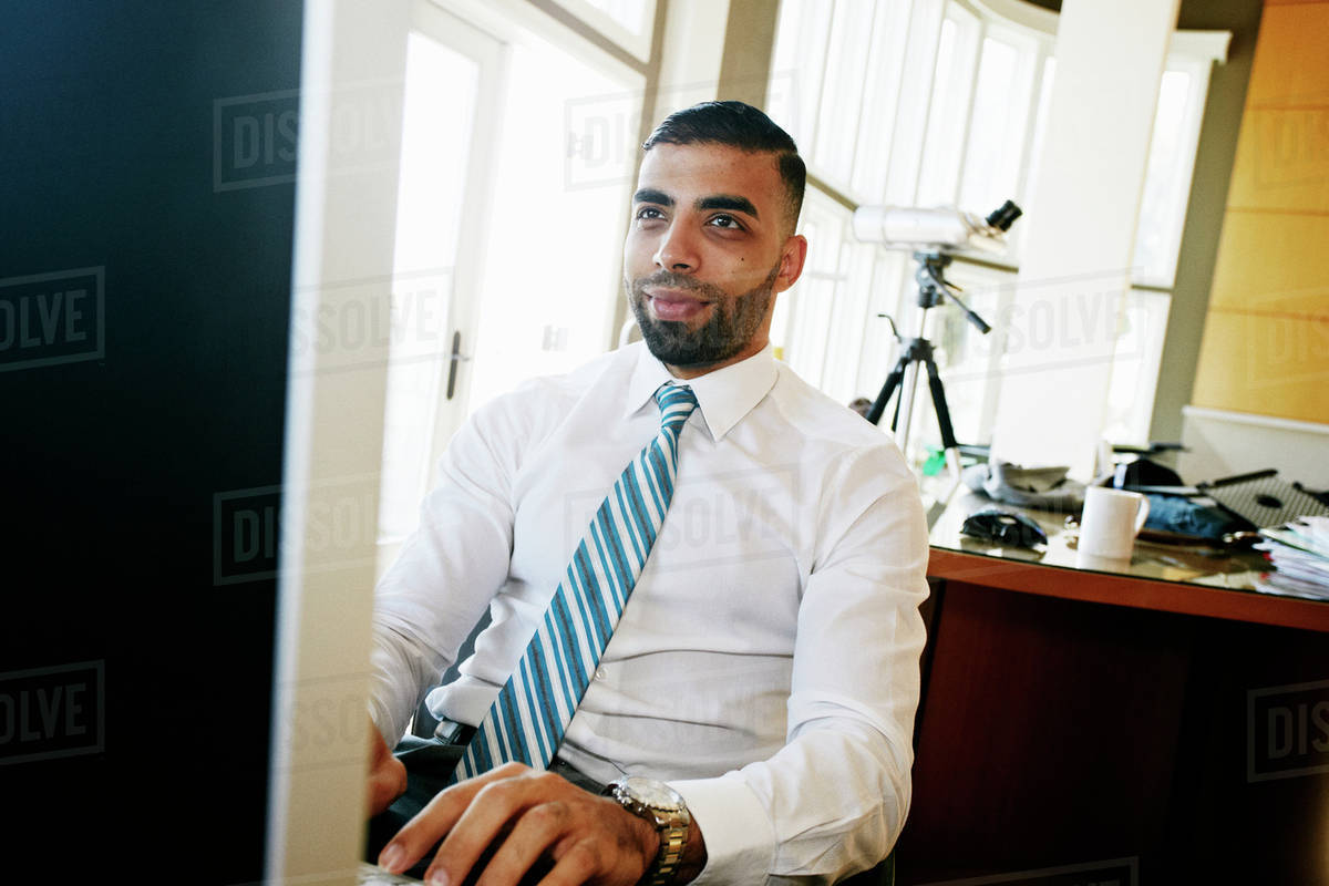 Middle Eastern businessman working at computer in office - Royalty-free ...