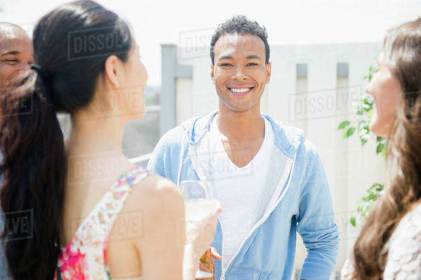Friends talking at party - Royalty-free Stock Photo | Dissolve