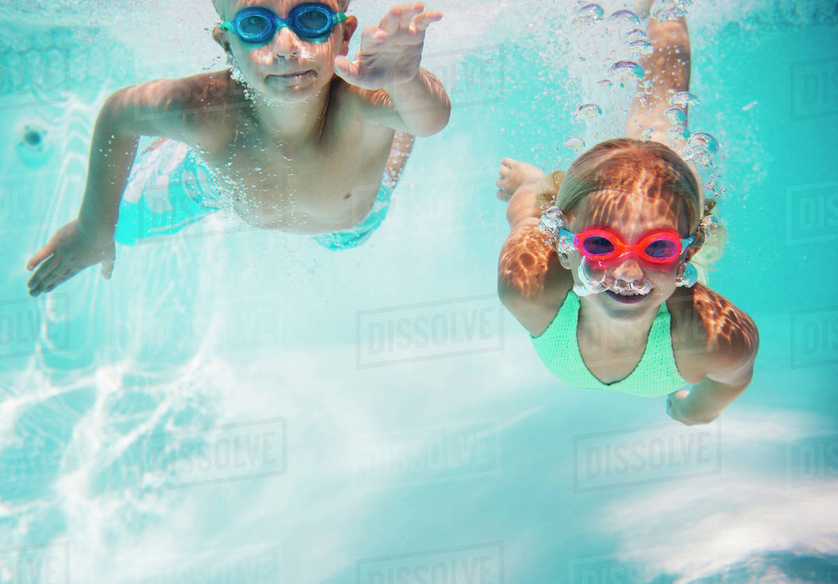 Caucasian children swimming underwater in pool - Royalty-free Stock ...