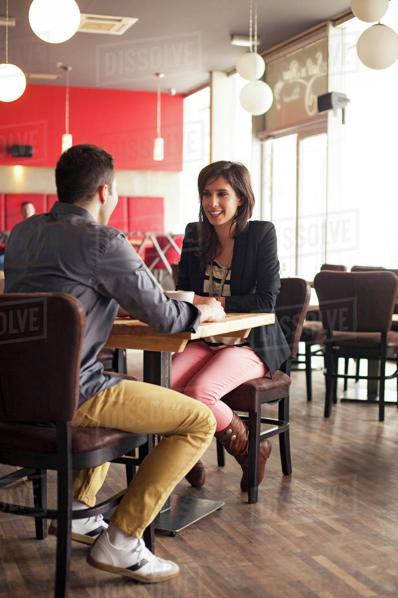 Couple drinking coffee together in cafe - Stock Photo - Dissolve