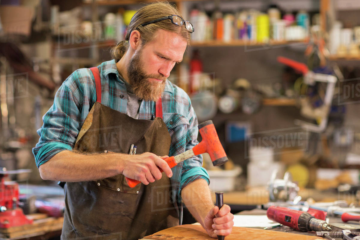 Caucasian craftsman working in workshop - Royalty-free Stock Photo ...
