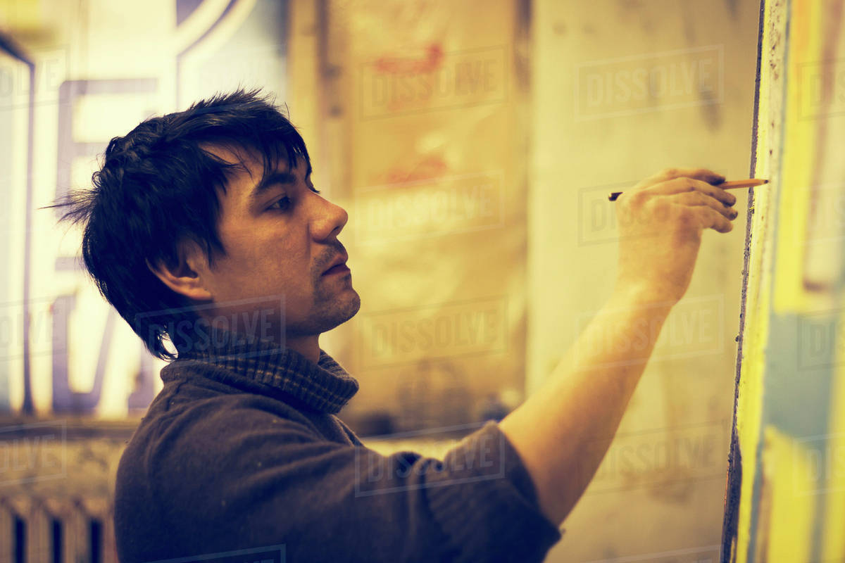 Asian artist drawing on canvas in studio - Royalty-free Stock Photo ...