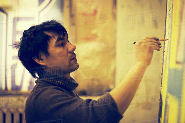 Asian artist drawing on canvas in studio - Royalty-free Stock Photo ...