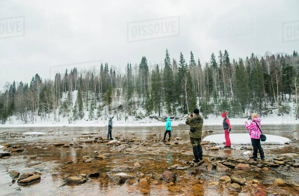 Caucasian hikers walking in rocky remote river - Royalty-free Stock ...