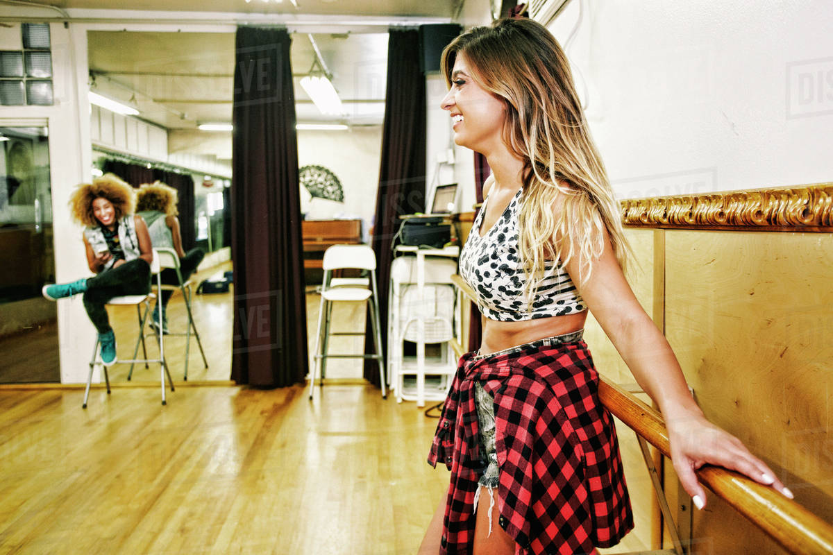 Dancer standing at bar in studio - Royalty-free Stock Photo | Dissolve