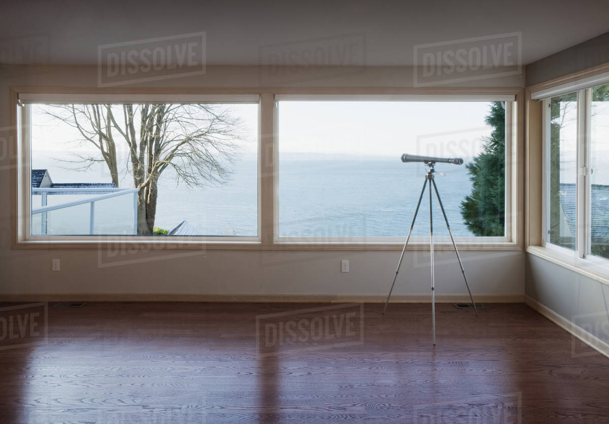Telescope looking out living room window to ocean - Royalty-free Stock ...