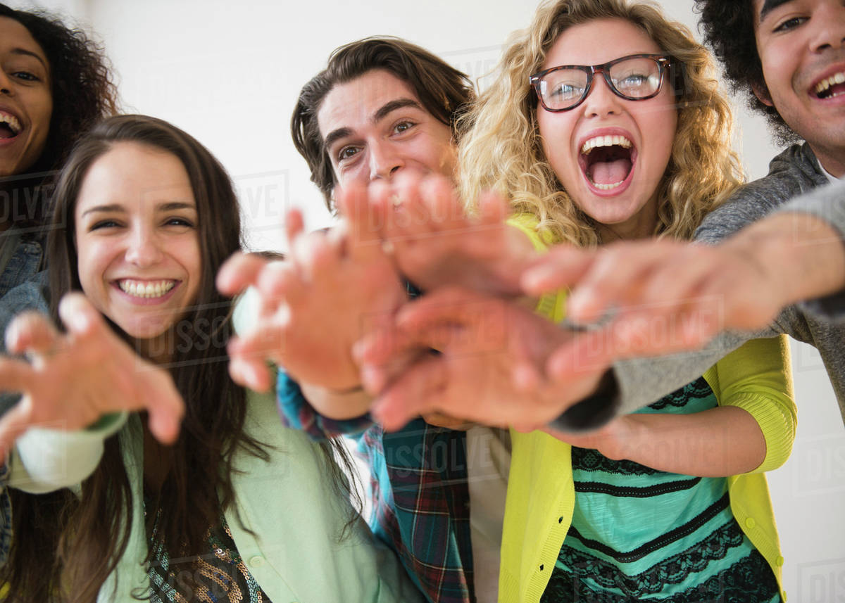 Friends reaching out together - Royalty-free Stock Photo | Dissolve