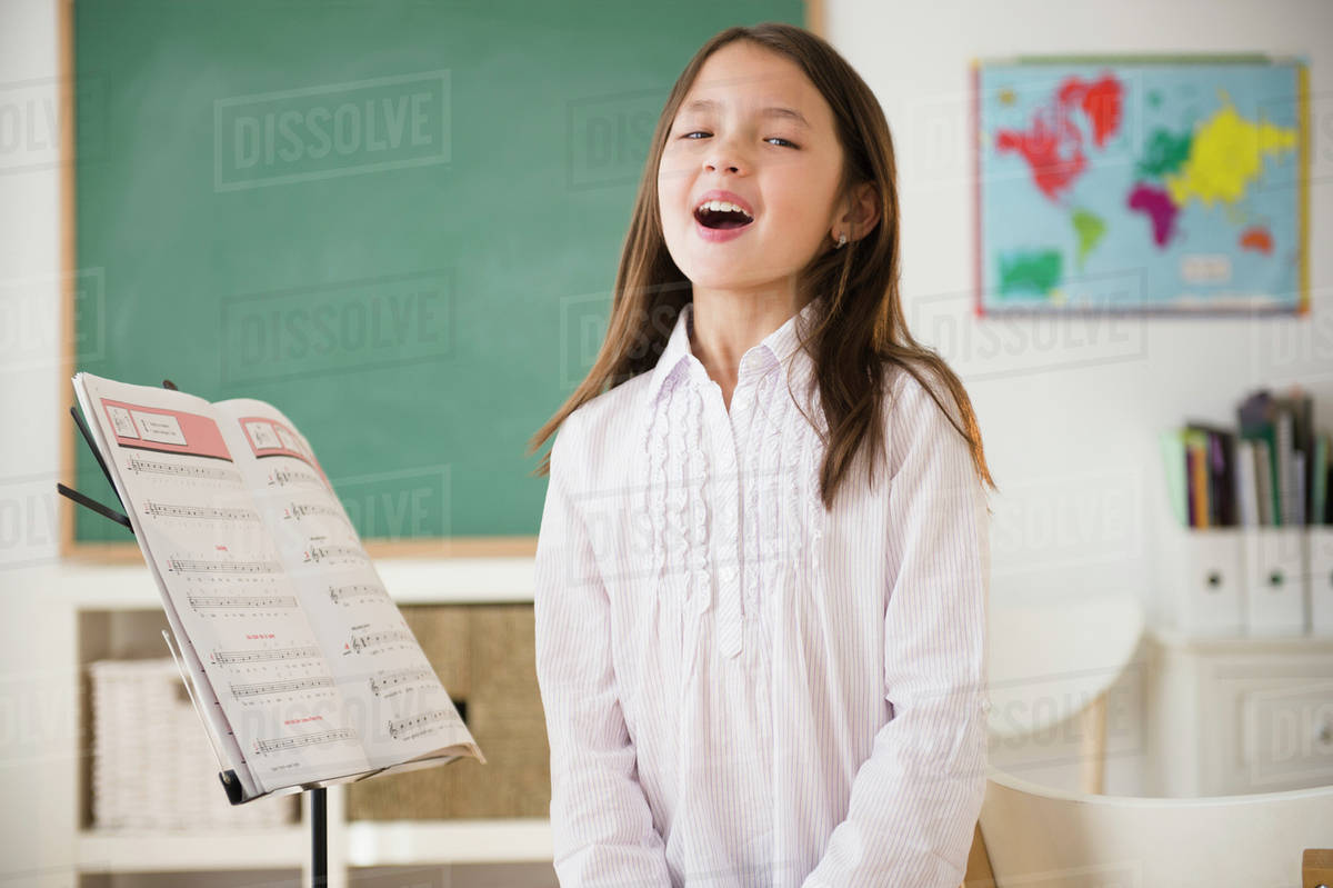 Mixed race girl in singing class - Royalty-free Stock Photo | Dissolve