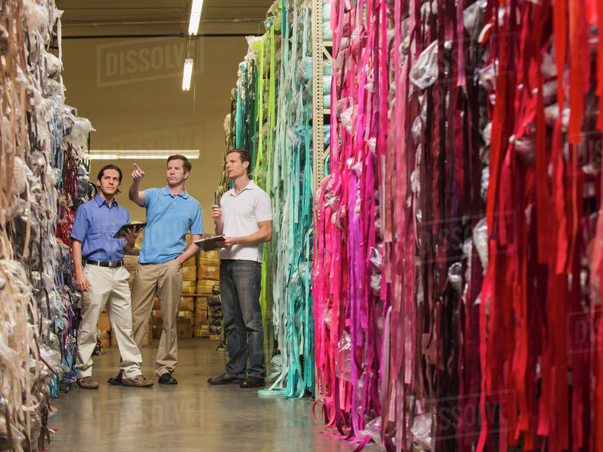 Workers examining fabric in textile factory - Royalty-free Stock Photo ...