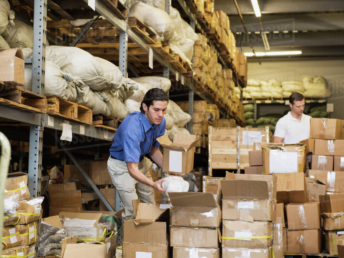 Workers stacking boxes in textile factory - Royalty-free Stock Photo ...