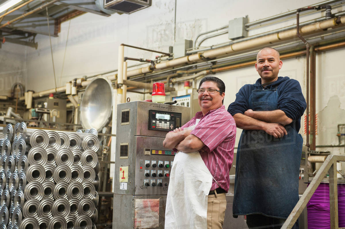 Hispanic workers smiling in textile factory - Royalty-free Stock Photo ...