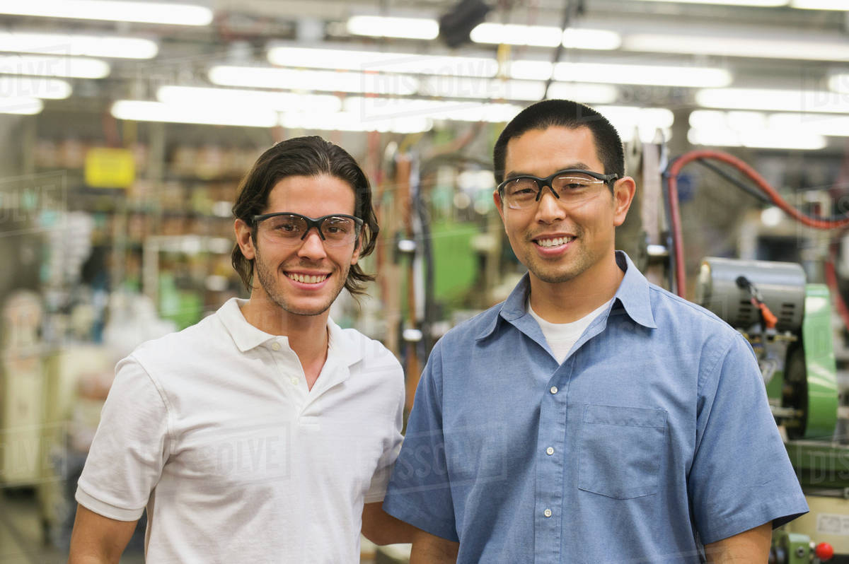 Workers smiling in textile factory - Royalty-free Stock Photo | Dissolve