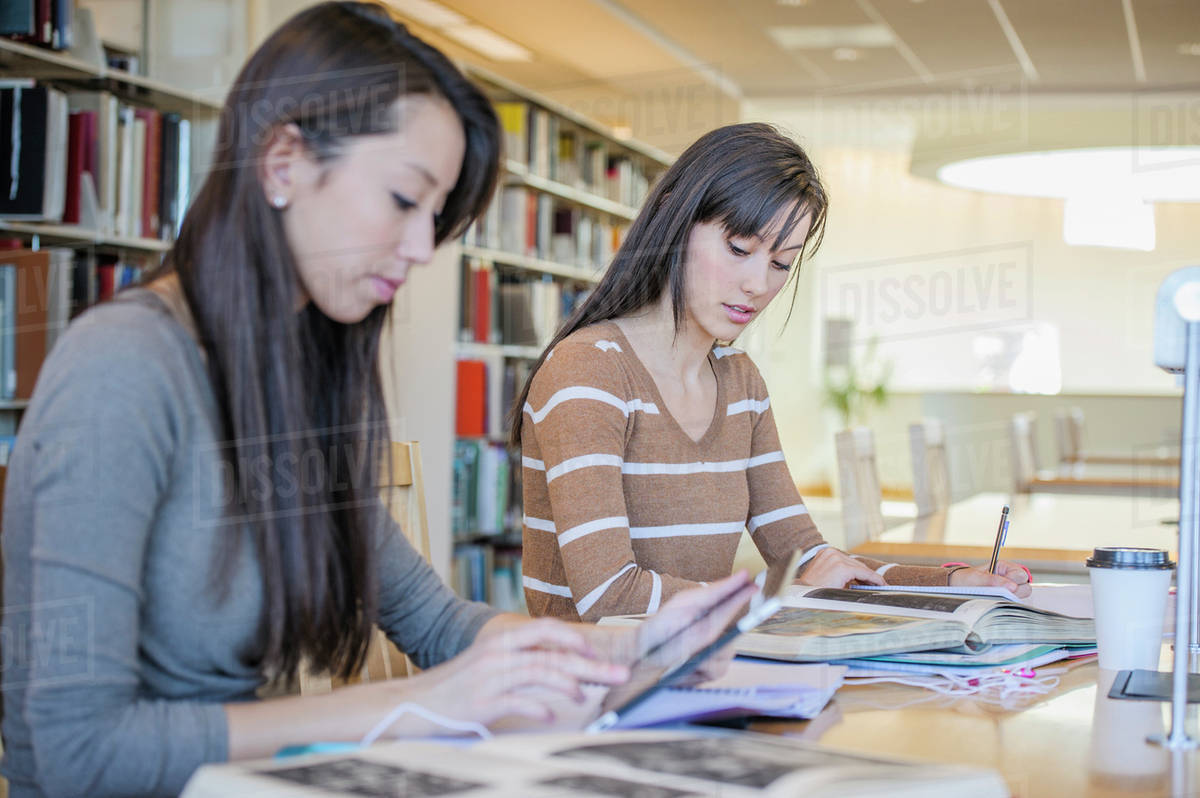 Students working at desk in library - Royalty-free Stock Photo | Dissolve