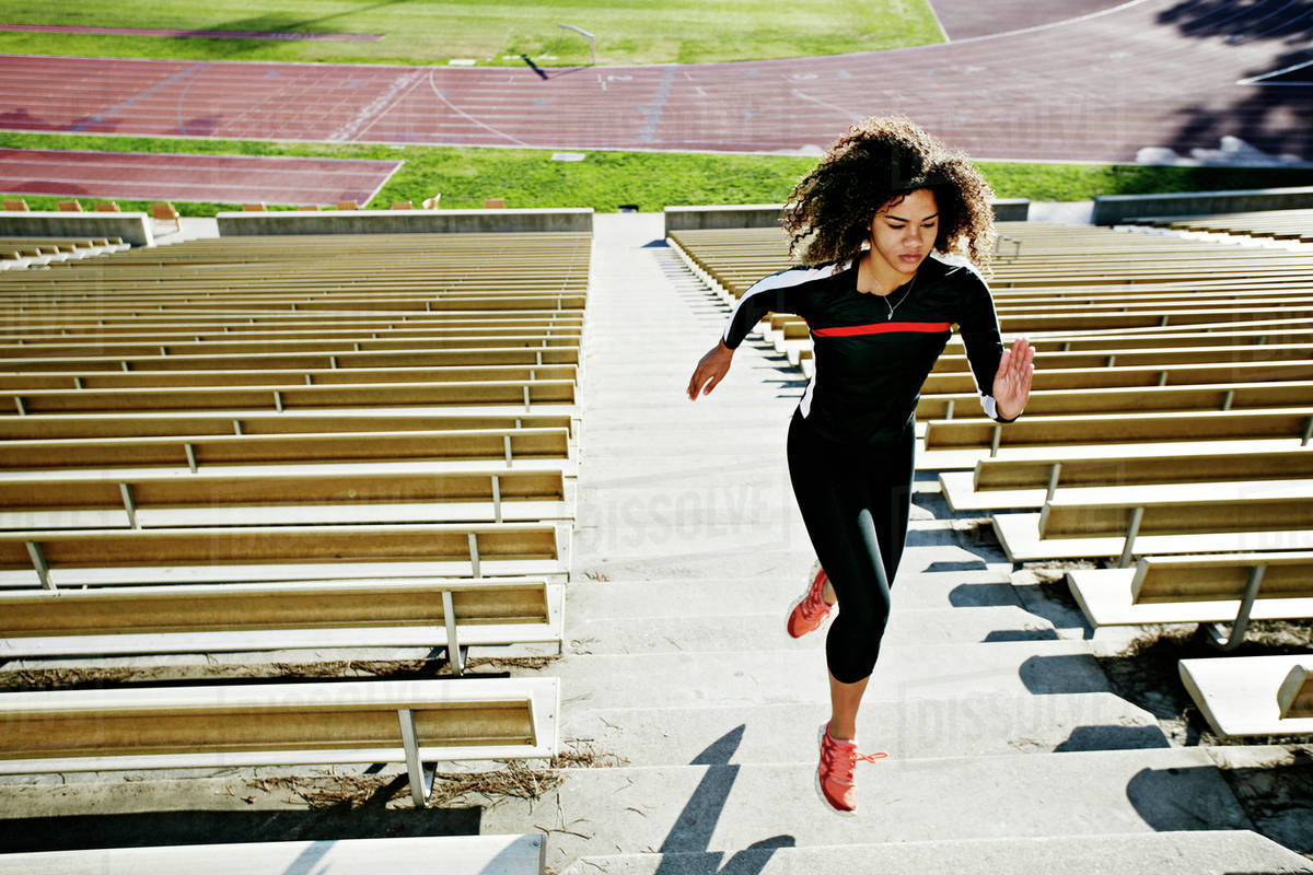 Mixed race runner training in stadium - Royalty-free Stock Photo | Dissolve