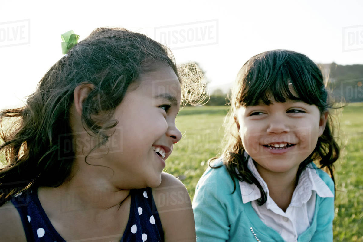 Girls playing in field - Royalty-free Stock Photo | Dissolve