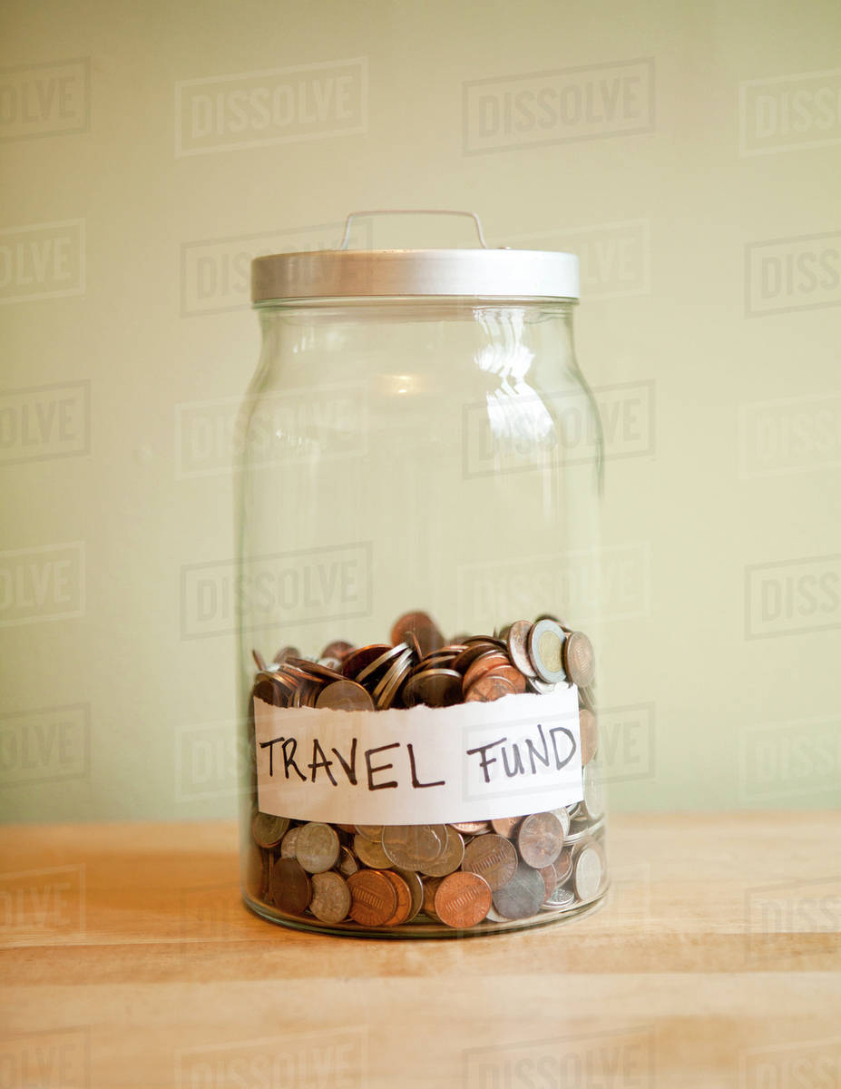 Coins in 'travel fund' jar - Royalty-free Stock Photo | Dissolve