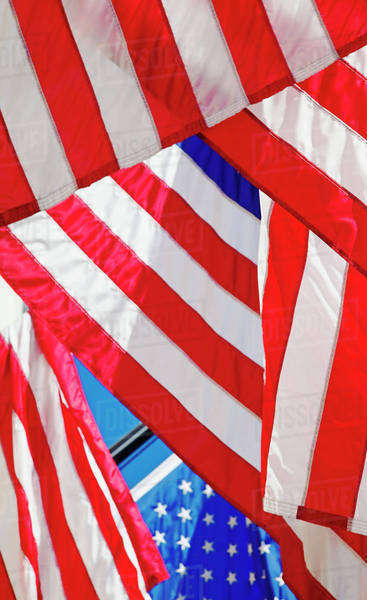 A collection of American flags hanging from a building - Royalty-free ...