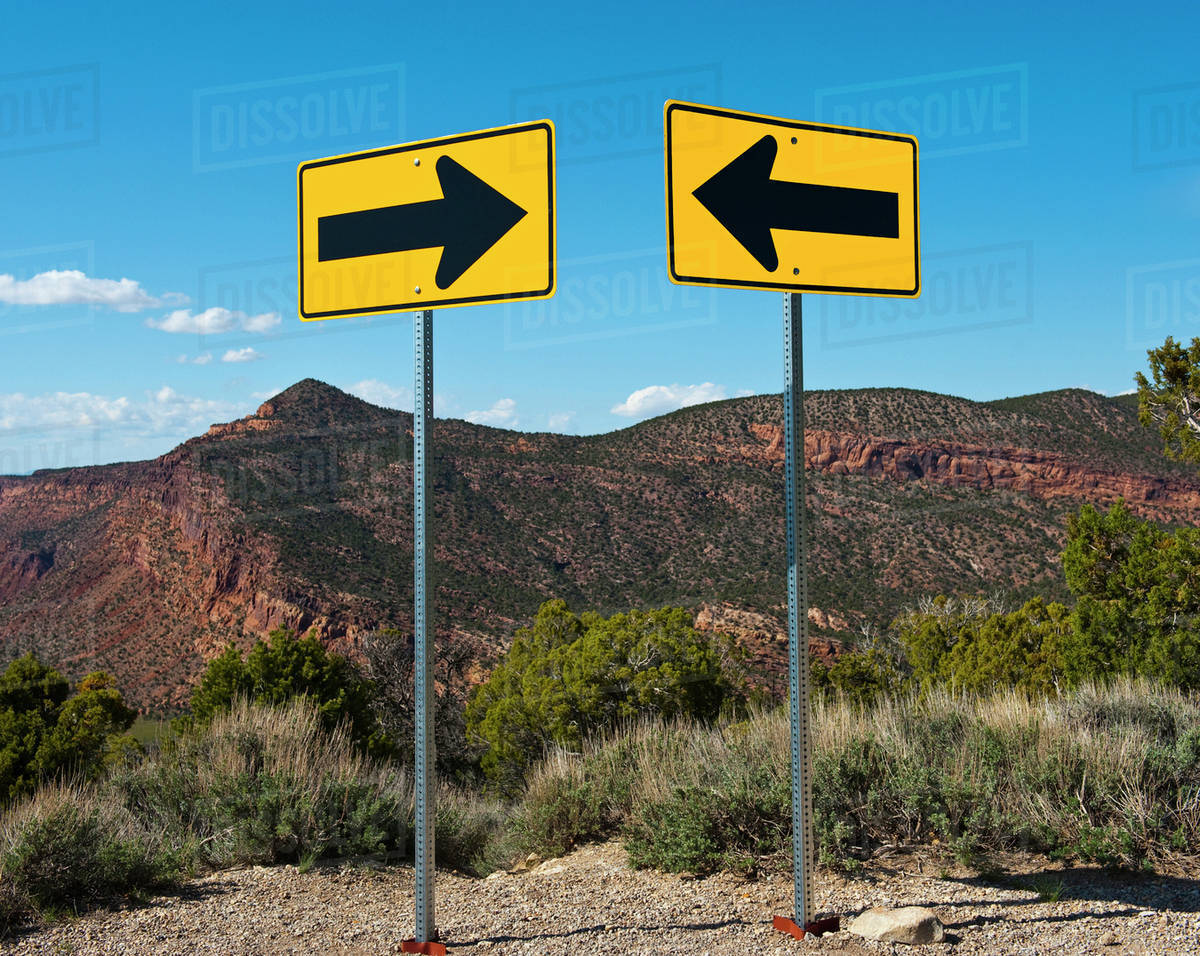 Contradictory Road Signs - Stock Photo - Dissolve