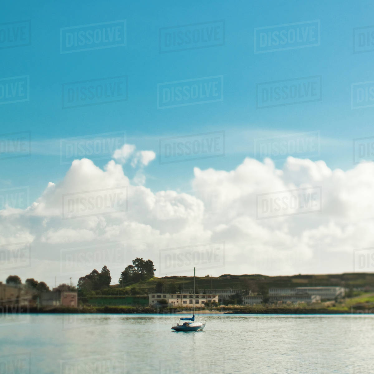 Small Sailboat Anchored in Bay - Royalty-free Stock Photo | Dissolve