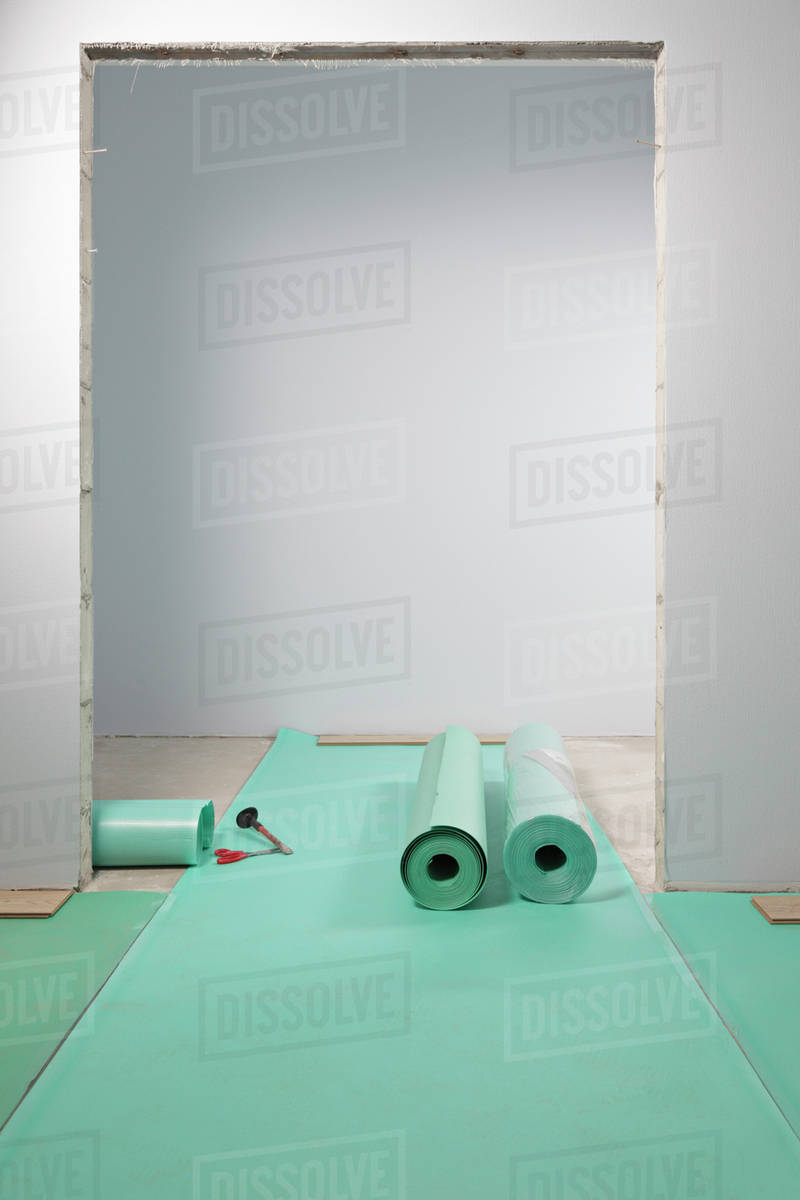 Rolls of underlay, or sub-flooring material, and a partly installed ...