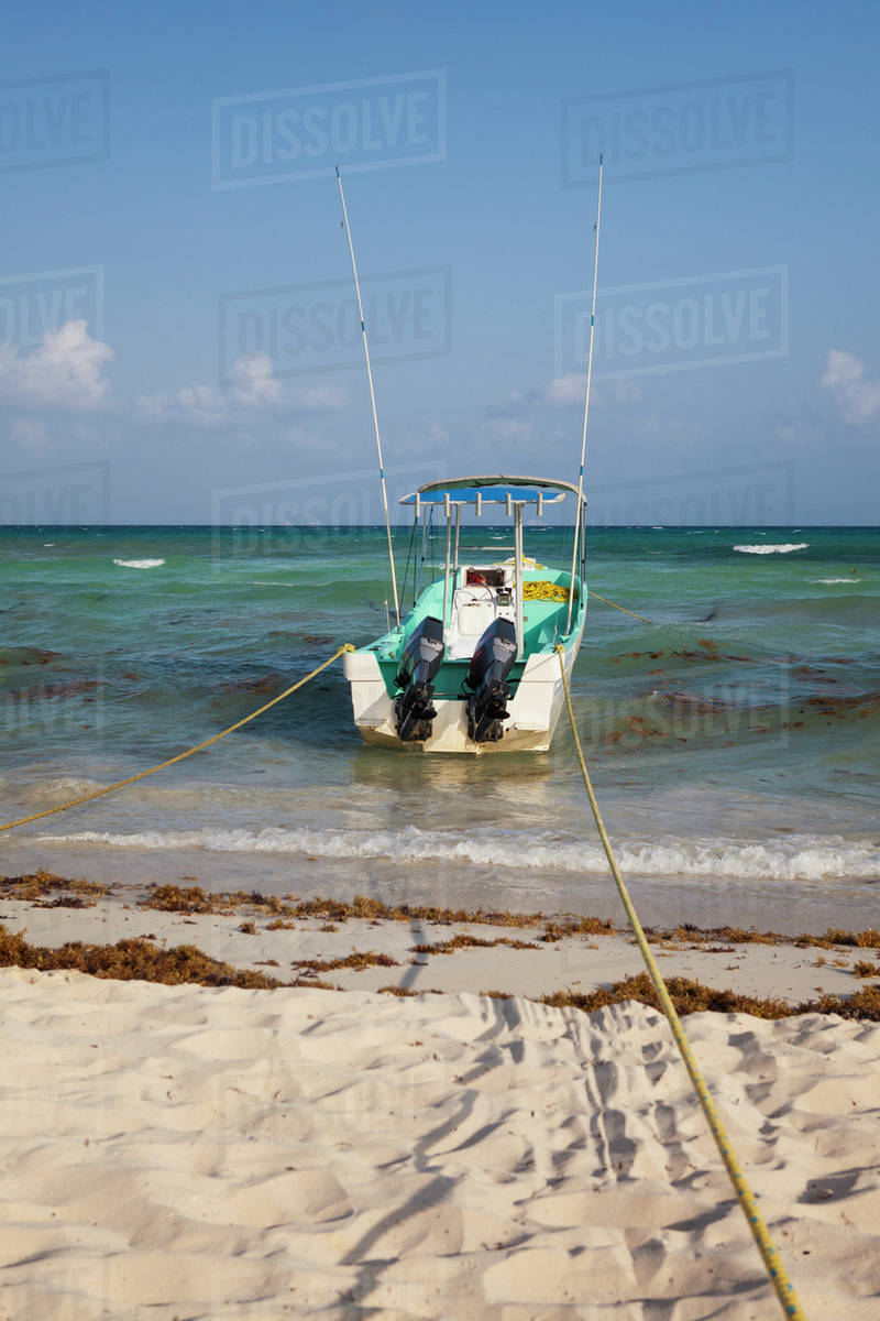 A fishing boat anchored at the edge of the water - Royalty-free Stock ...