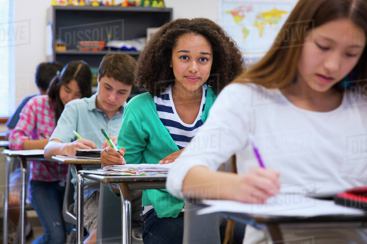 Students taking notes in class - Stock Photo - Dissolve