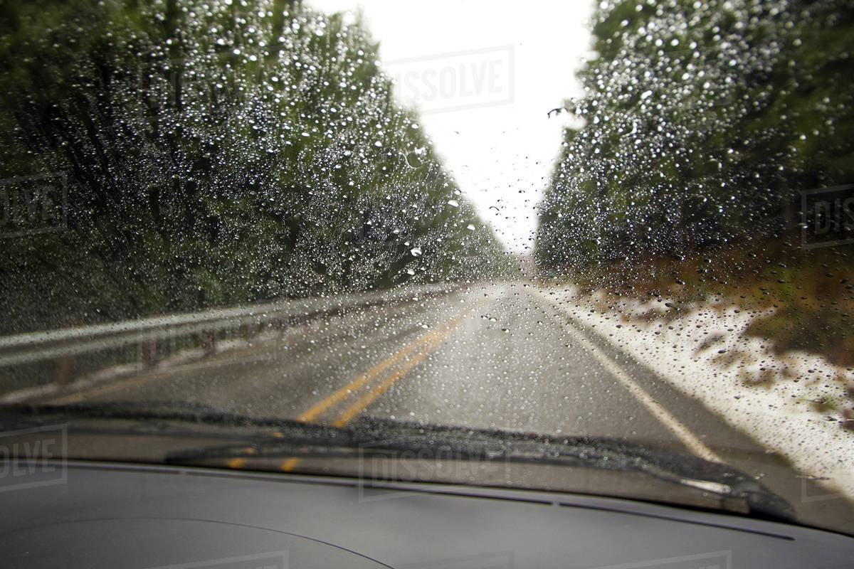 Close up of rain on car windshield - Stock Photo - Dissolve